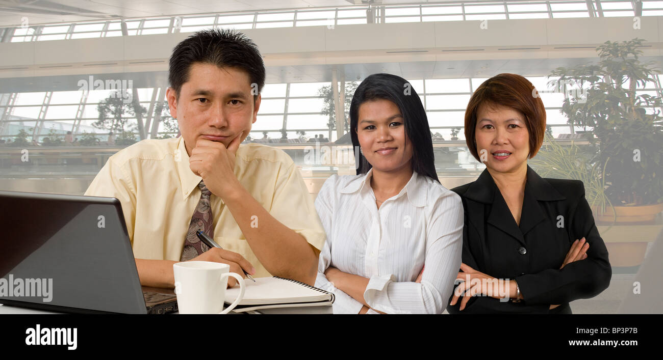 Three business office workers standing together Stock Photo - Alamy