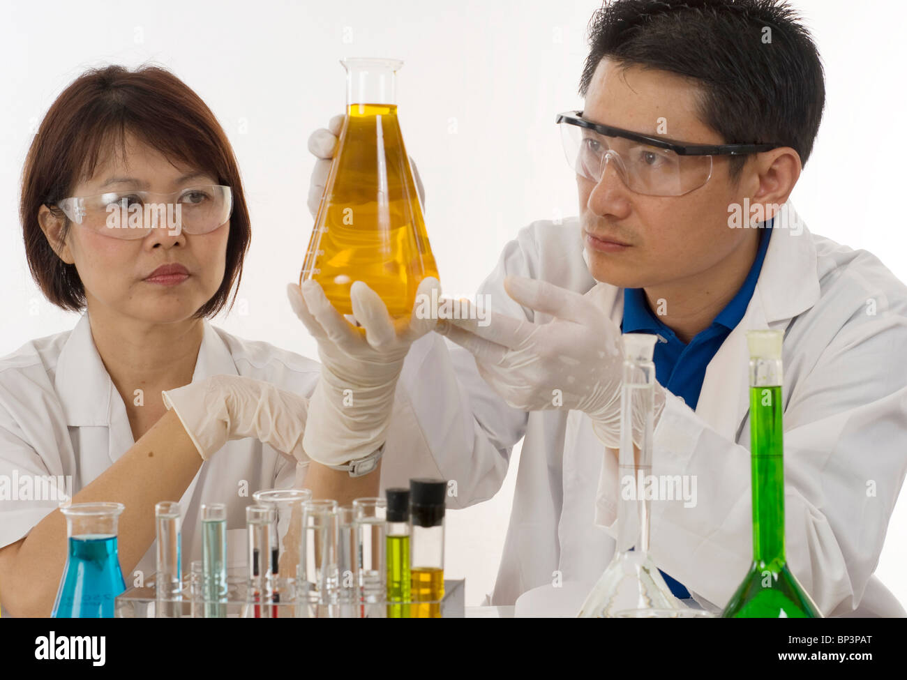 Scientists examining chemicals in a laboratory Stock Photo - Alamy