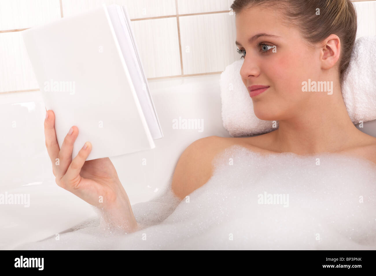 Young woman reading book in the bathtub Stock Photo - Alamy