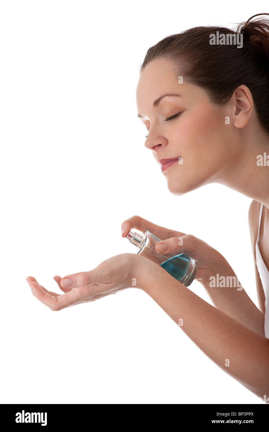 Beautiful woman applying perfume on her wrist Stock Photo - Alamy