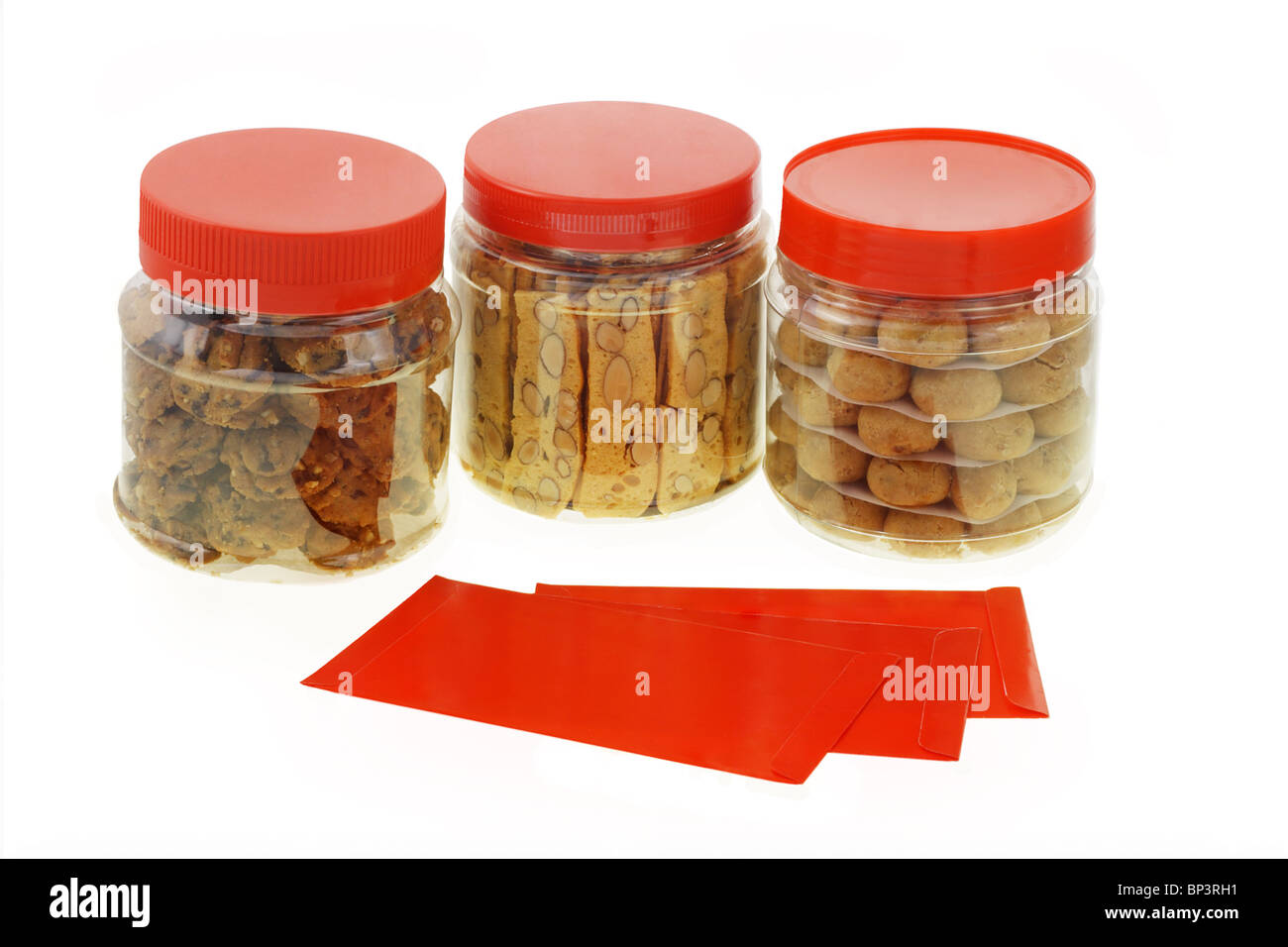 Chinese New Year red packets and cookies in plastic containers Stock ...