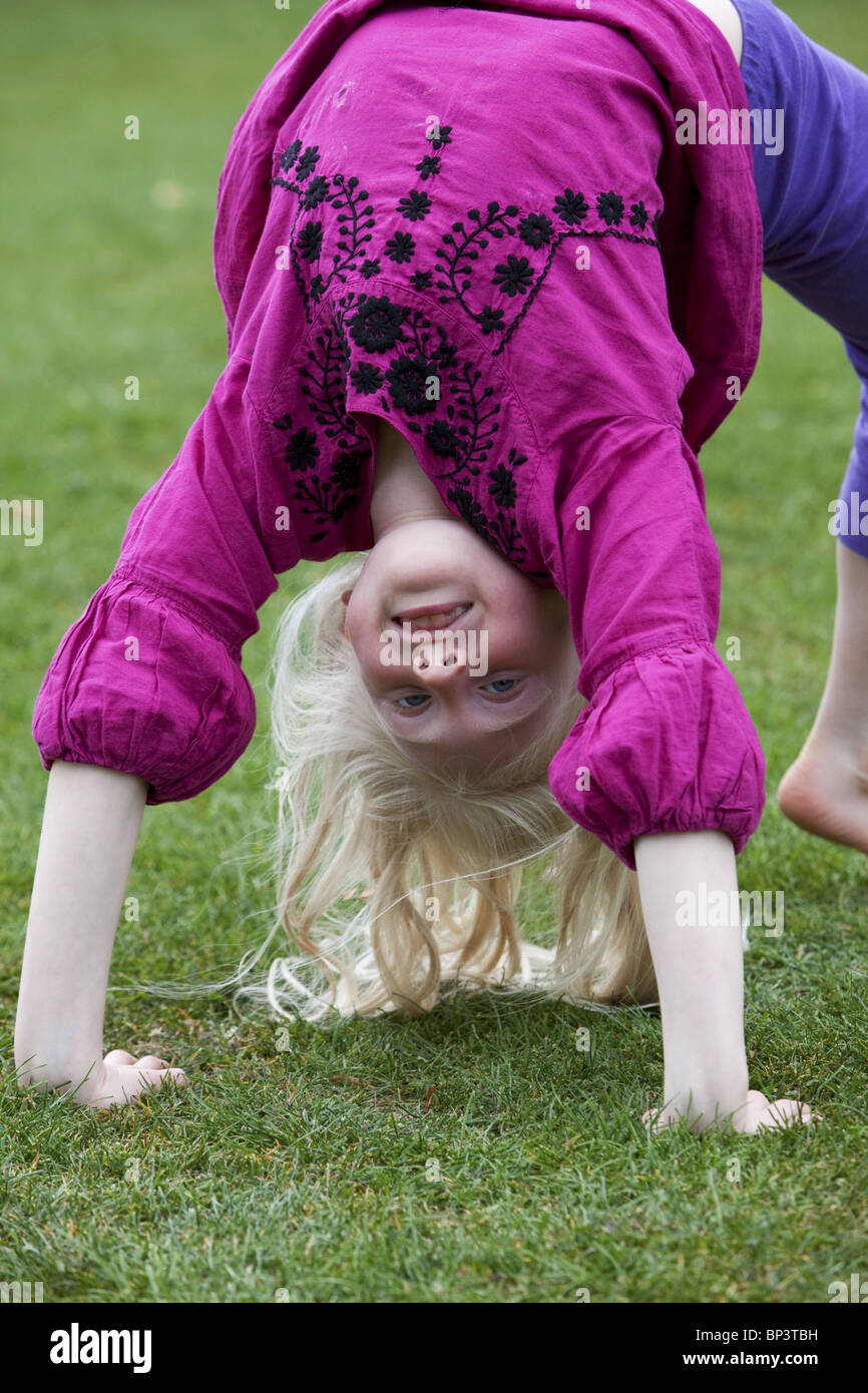 Blonde girl preforming gymnastics Stock Photo - Alamy