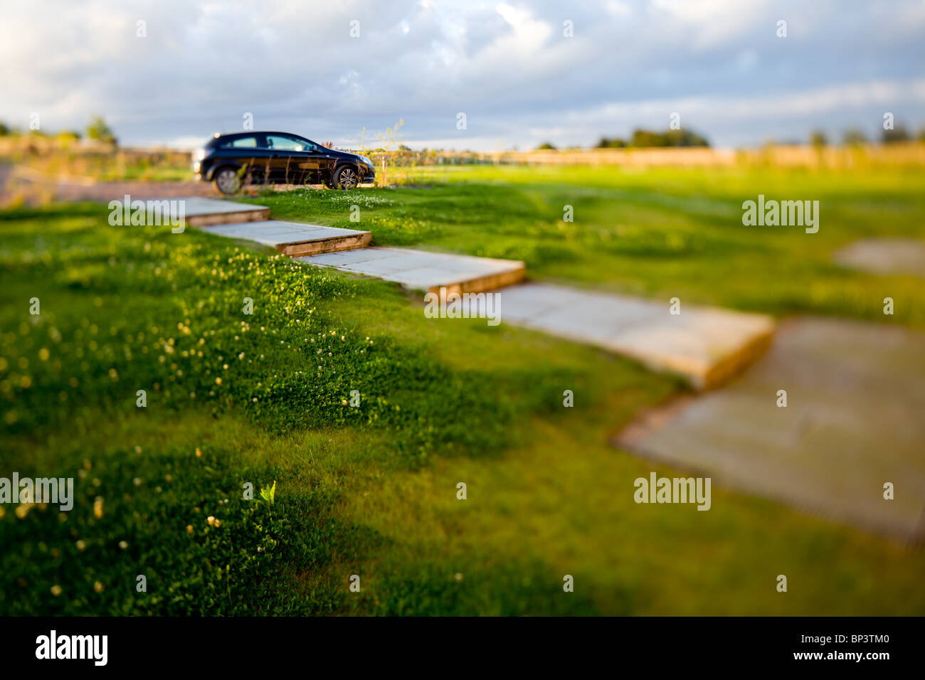 A tilt shift photograph of a black car in the distance Stock Photo - Alamy