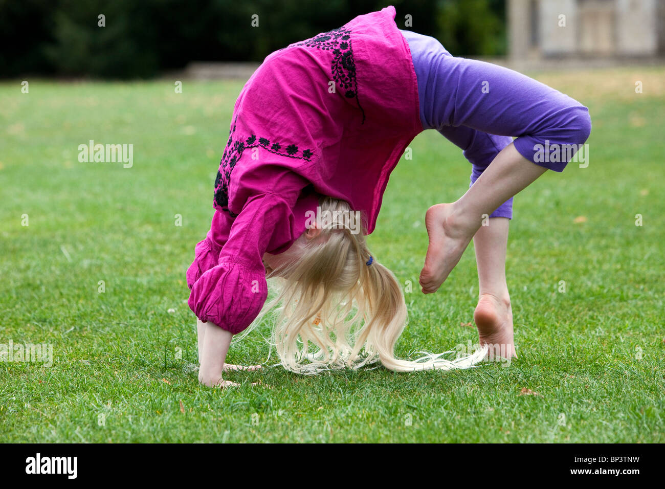 Blonde girl preforming gymnastics Stock Photo - Alamy