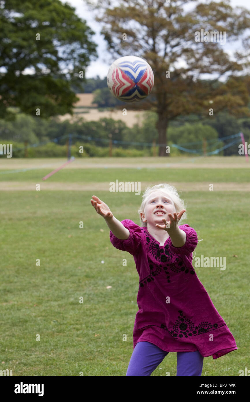 Blonde little girl playing rugby Stock Photo - Alamy