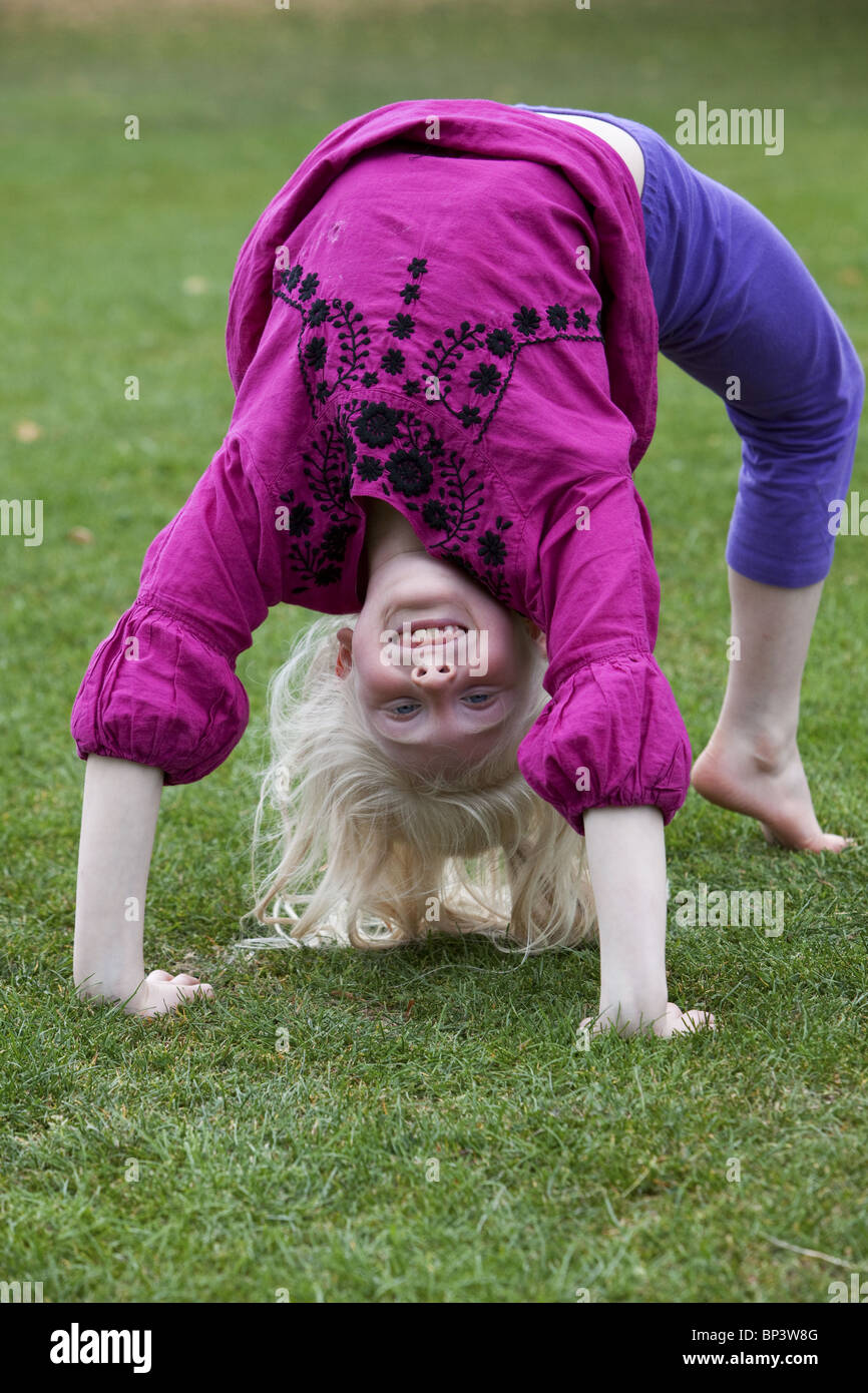 Blonde girl preforming gymnastics Stock Photo - Alamy
