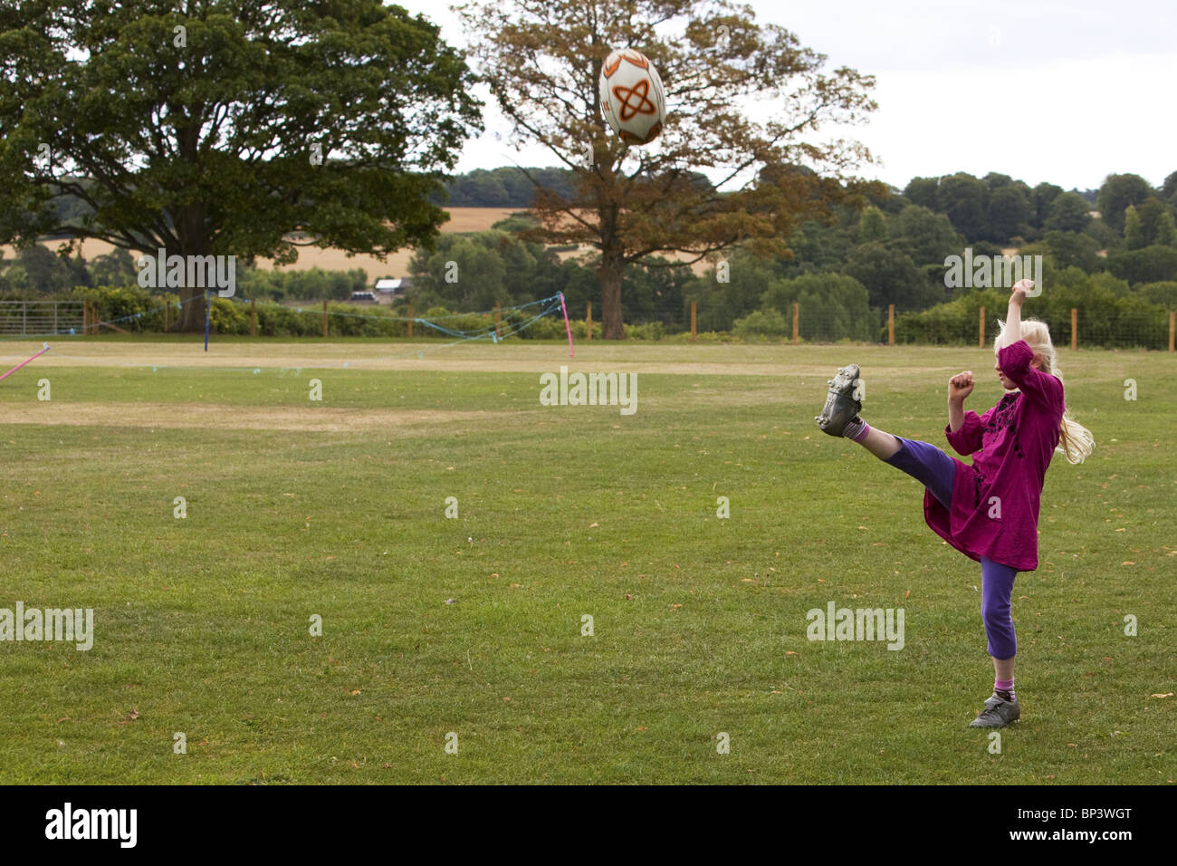 Blonde little girl playing rugby Stock Photo - Alamy