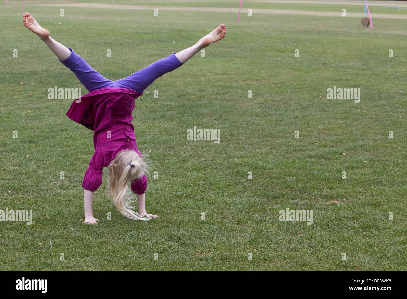 Blonde girl preforming gymnastics Stock Photo - Alamy