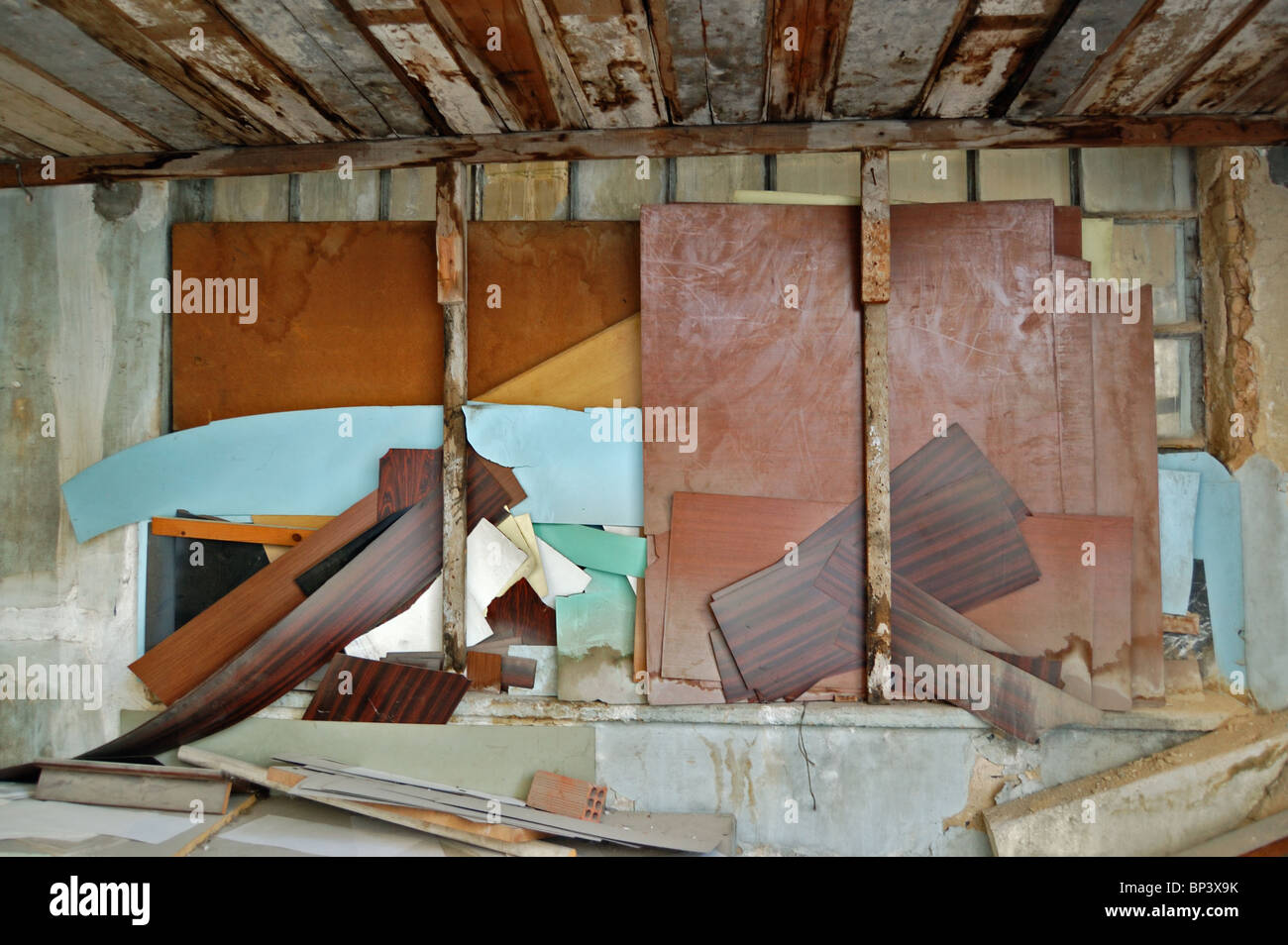 Window boarded up with broken wood planks. Abandoned factory interior ...