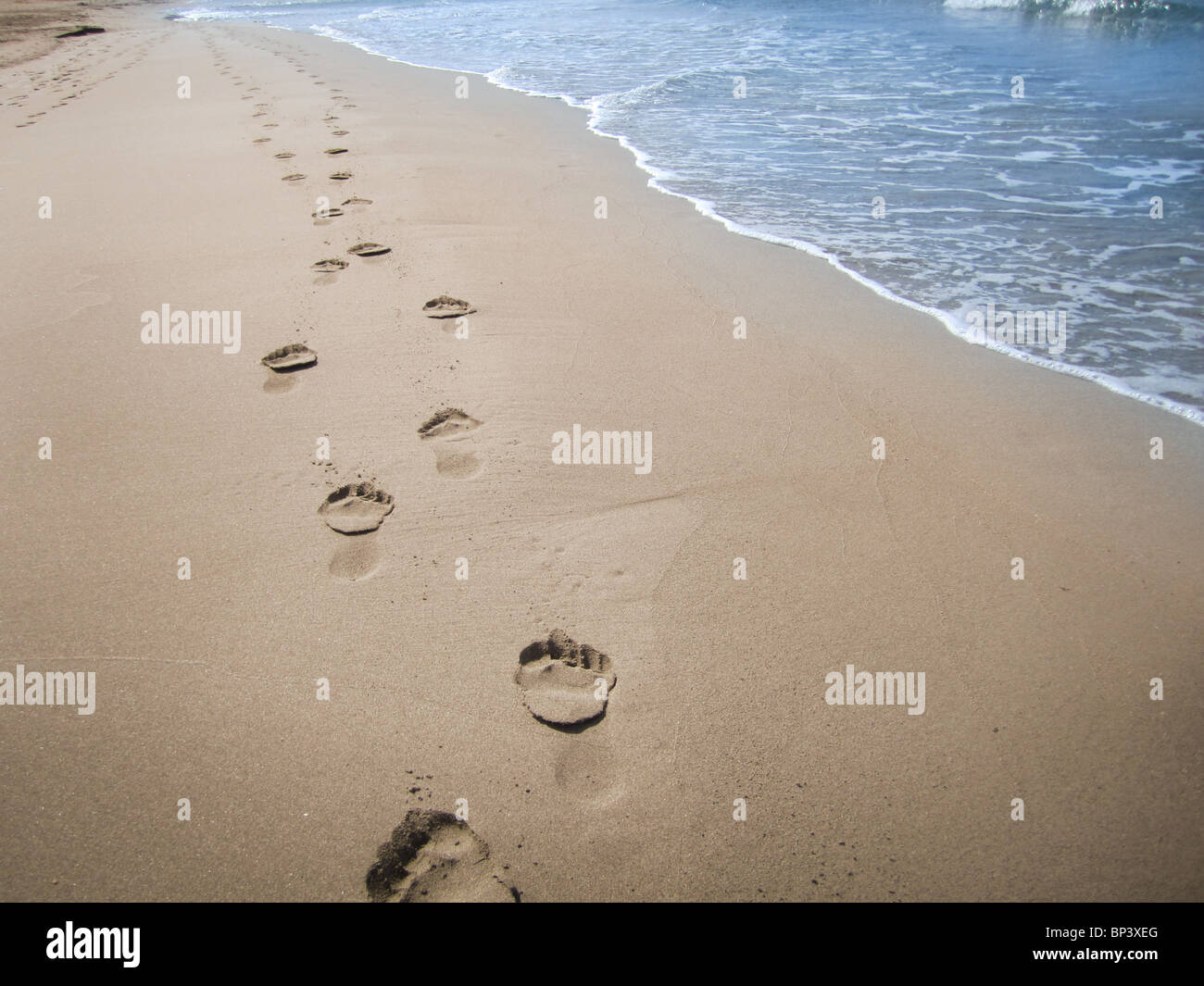 Footprints in wet sand of beach, Spain Stock Photo - Alamy