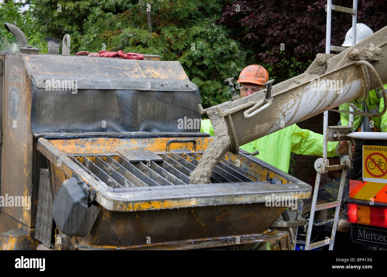 Concrete being transfered from transporter into concrete pump Stock ...
