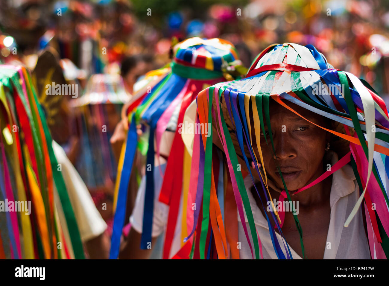 A Negritas dancer with colorful ribbons on a hat takes part in the ...