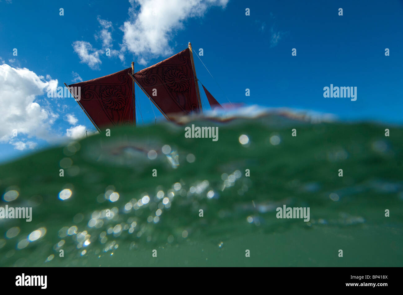 The sails of a traditional Pacific Island Waka catamaran seen from ...