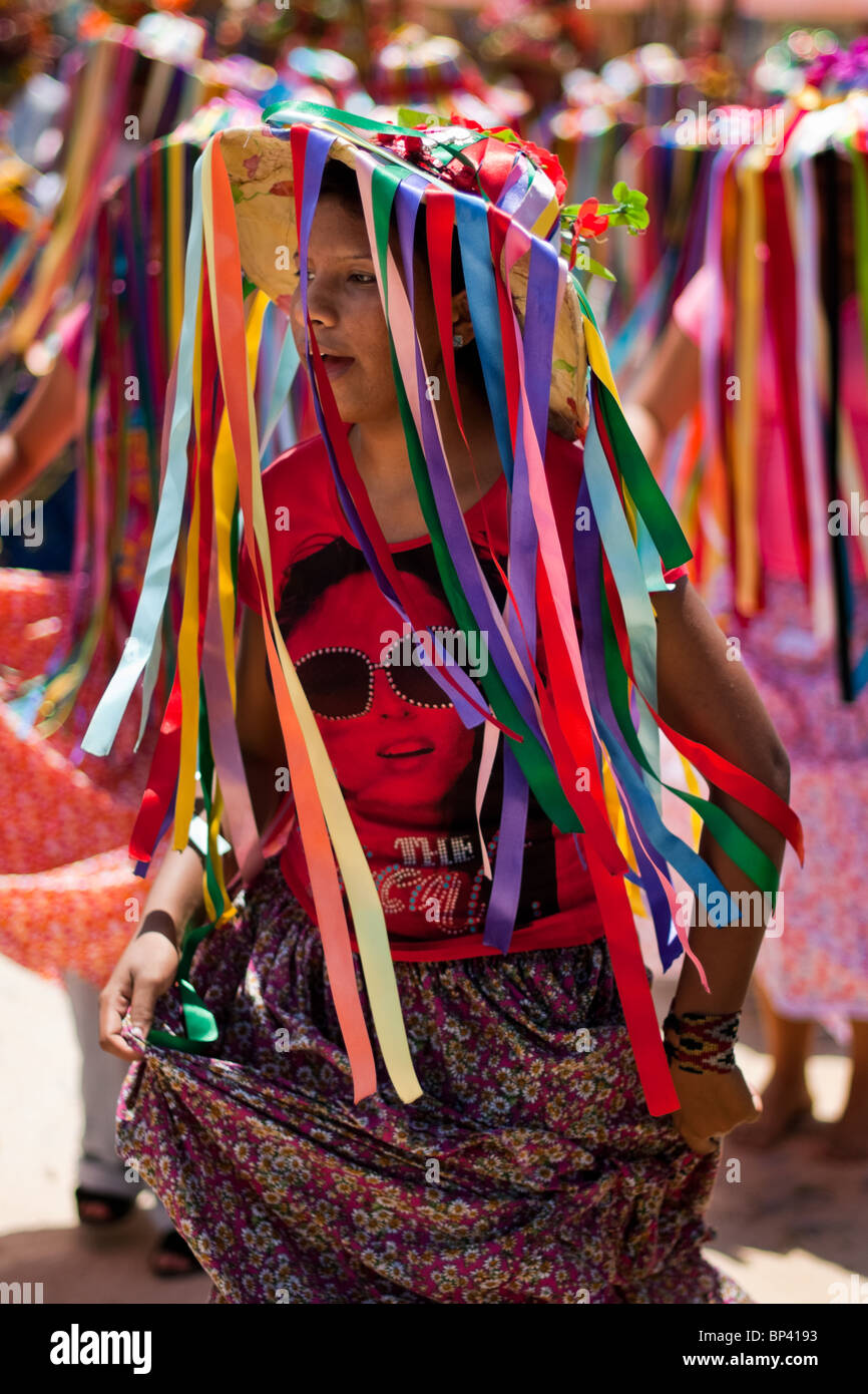 A Negritas dancer with colorful ribbons on a hat dances in the ...