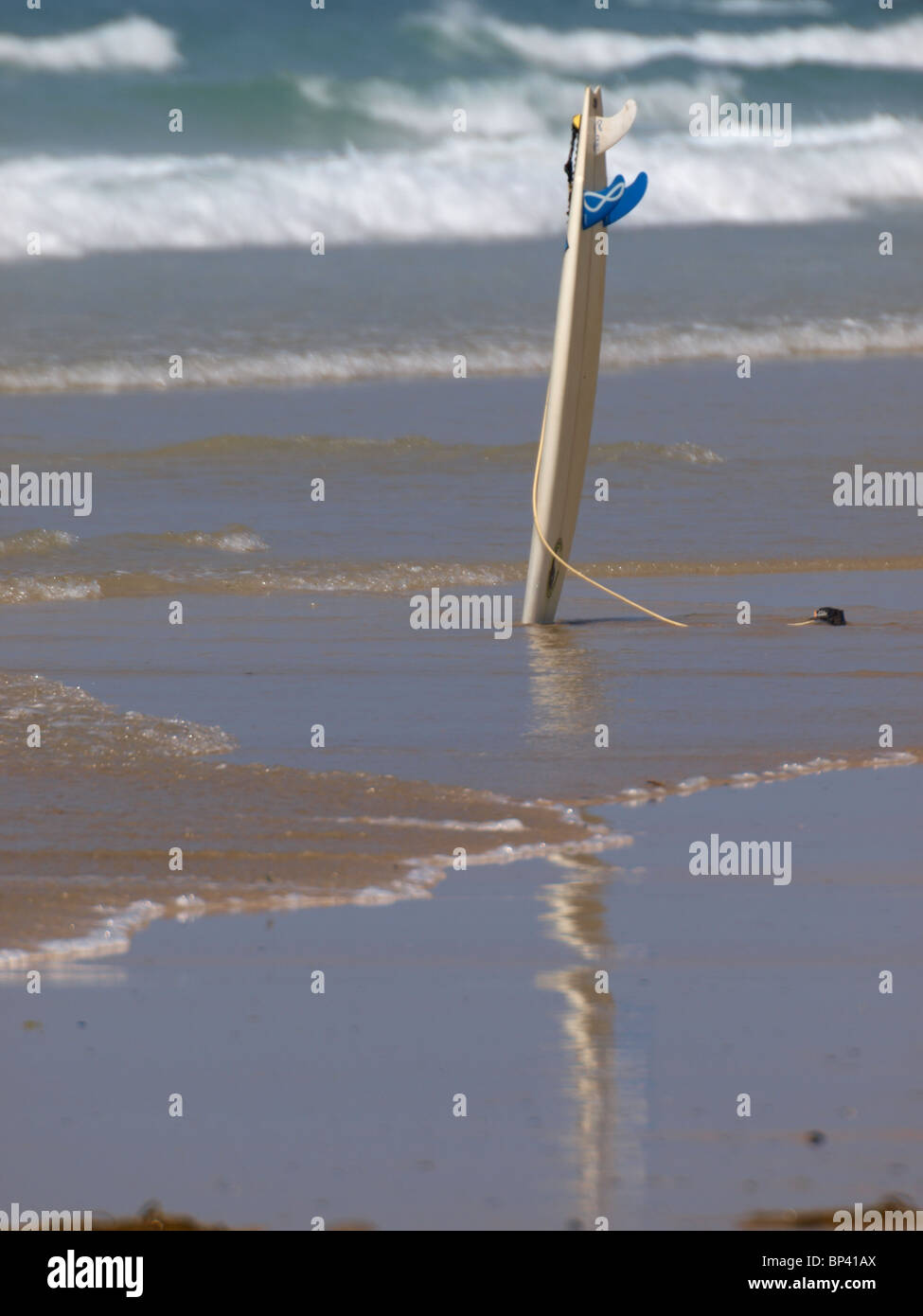 Surfboard upright in the sand, Watergate Bay, Cornwall, UK Stock Photo ...