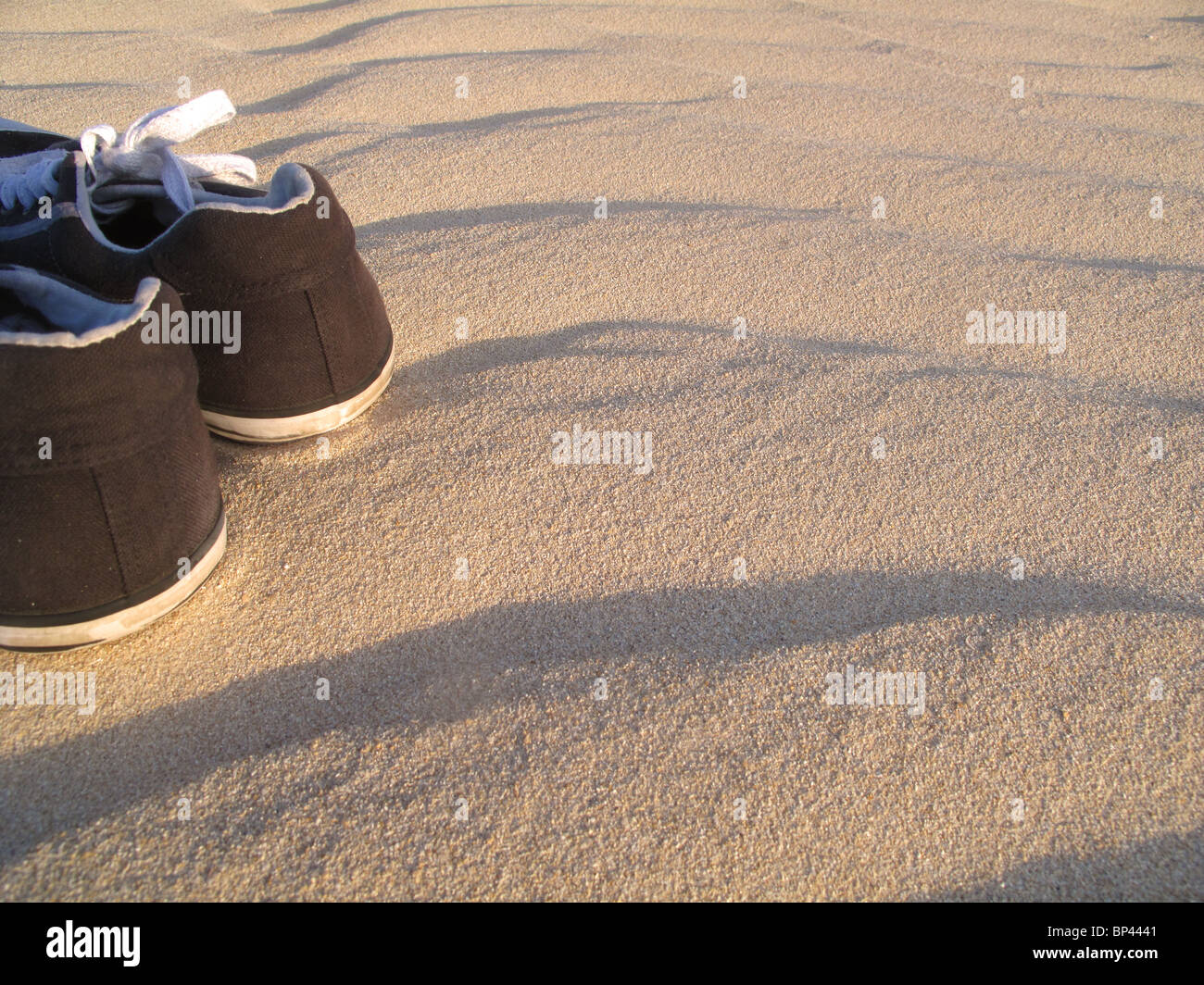 Trainers on sandy beach Stock Photo - Alamy
