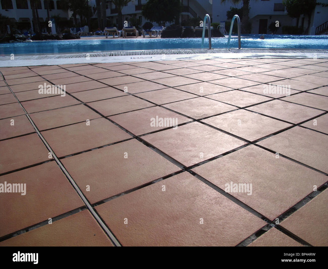 Tiled poolside terrace Stock Photo - Alamy