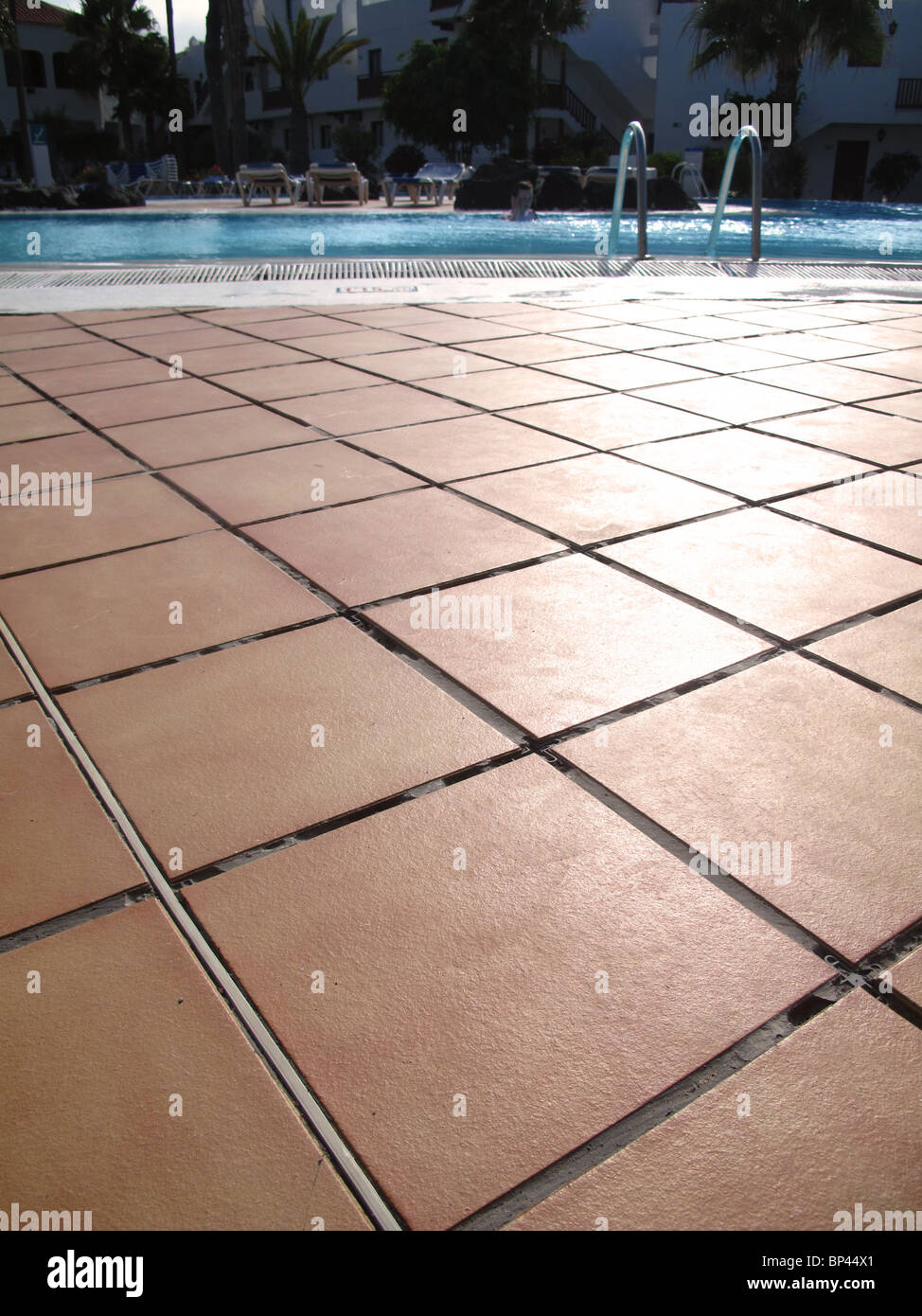 Tiled poolside terrace Stock Photo - Alamy
