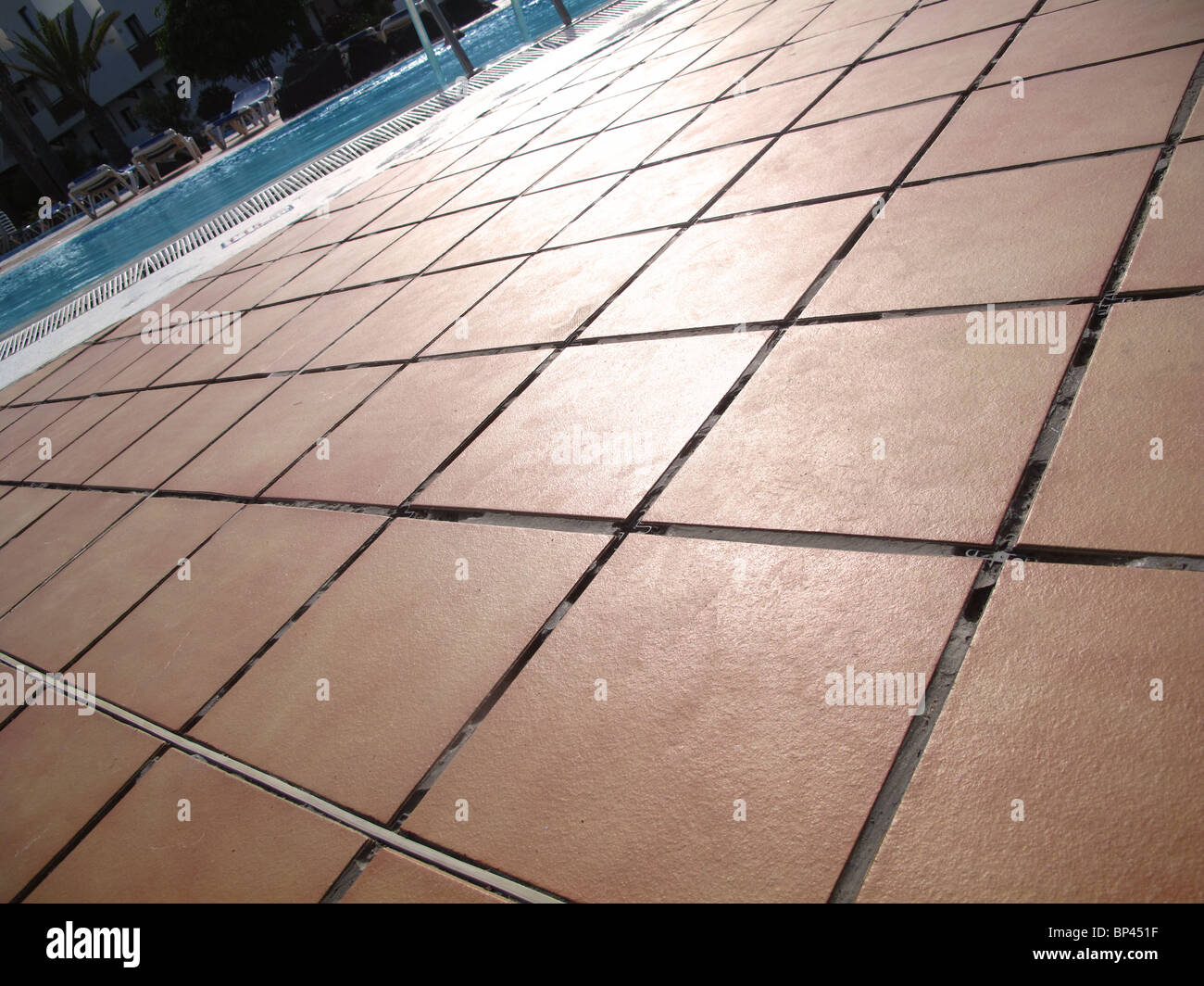 Tiled poolside terrace Stock Photo - Alamy