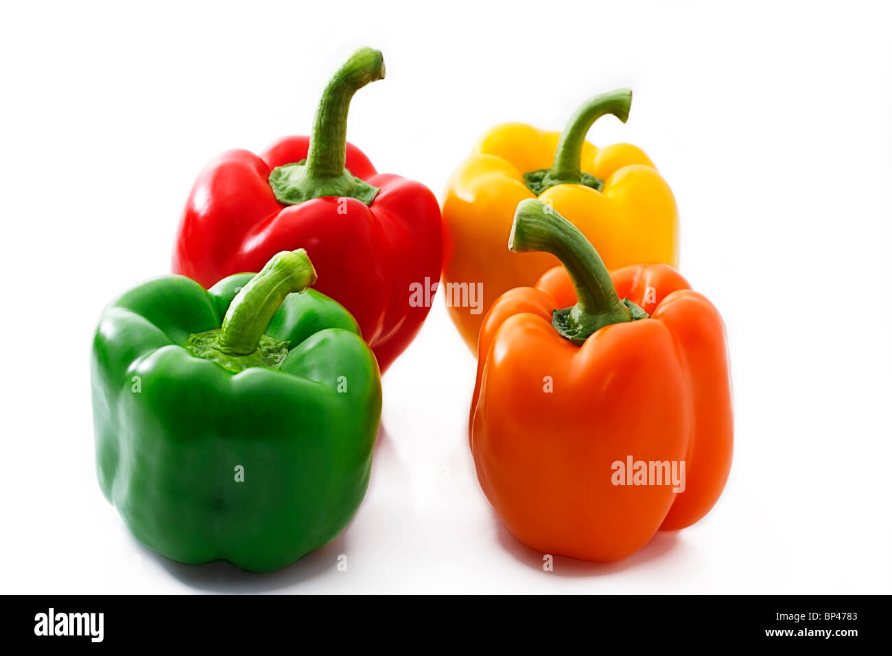 four colorful paprikas on white background Stock Photo - Alamy