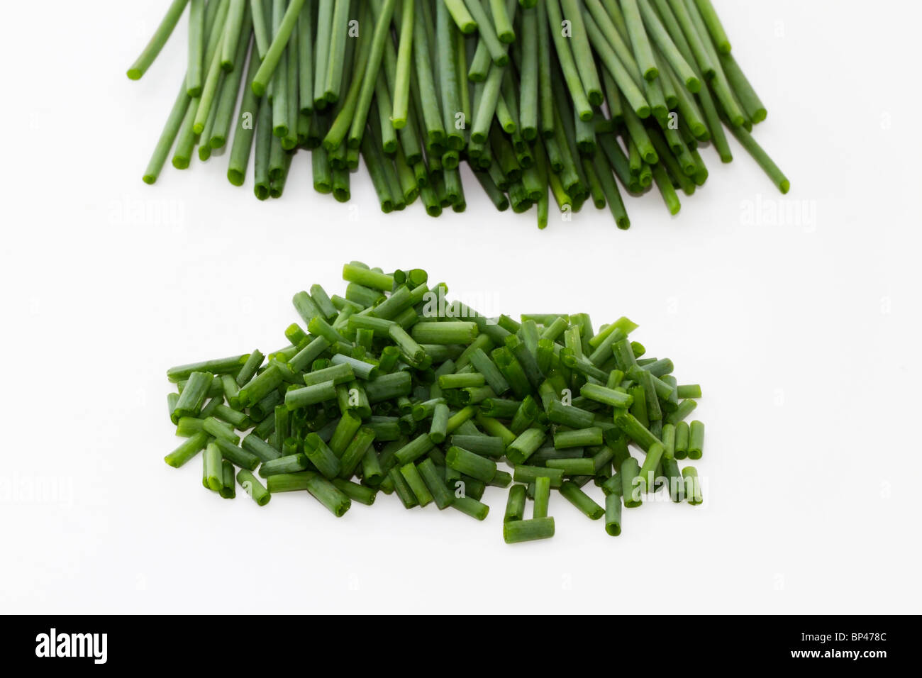 some chopped chives and chives in background over white Stock Photo - Alamy