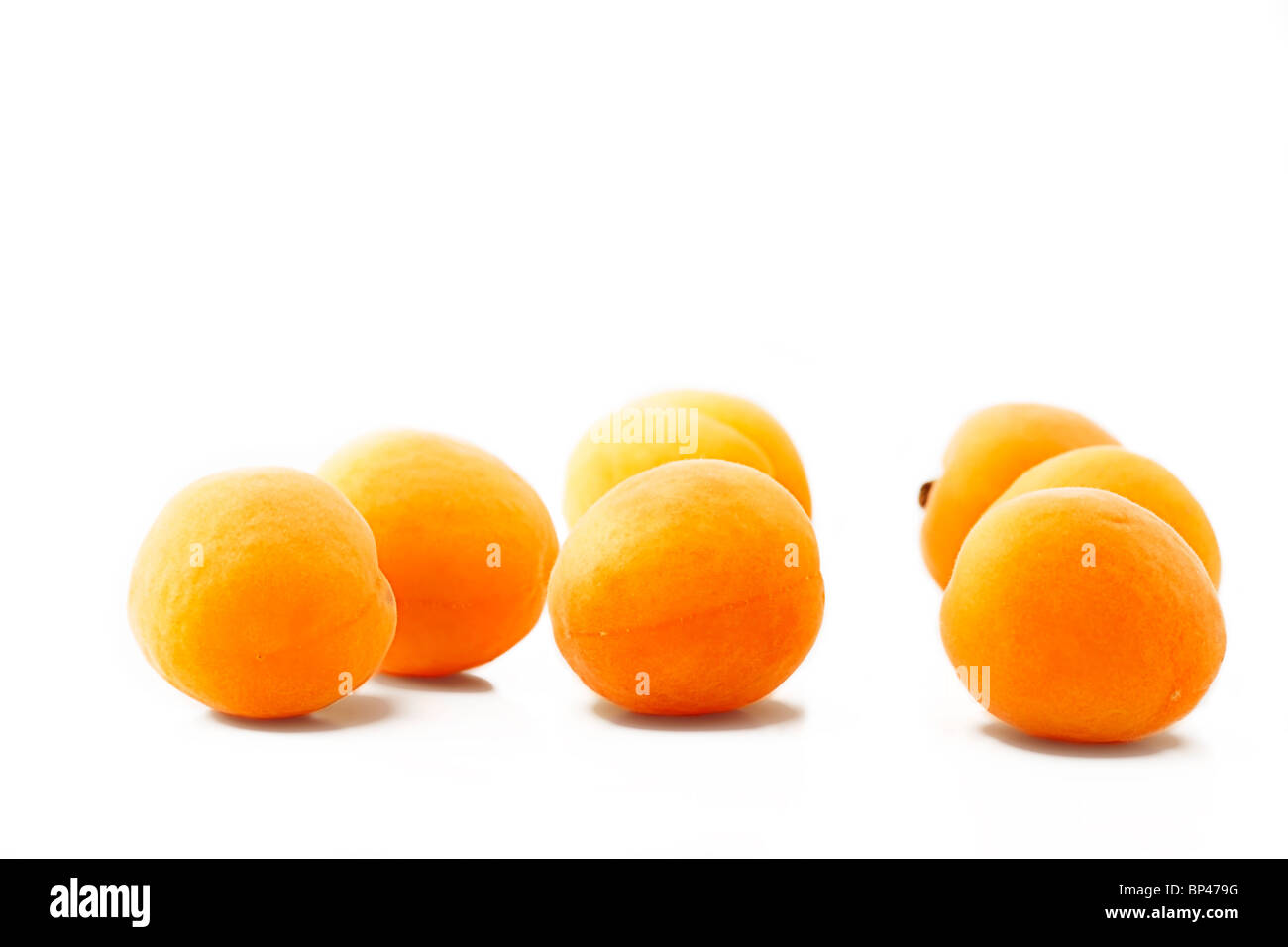 seven orange apricots on white background Stock Photo - Alamy
