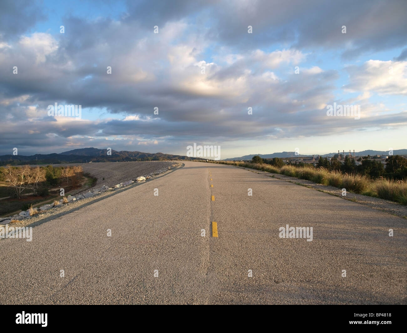 Levee road and California winter storm clouds Stock Photo - Alamy