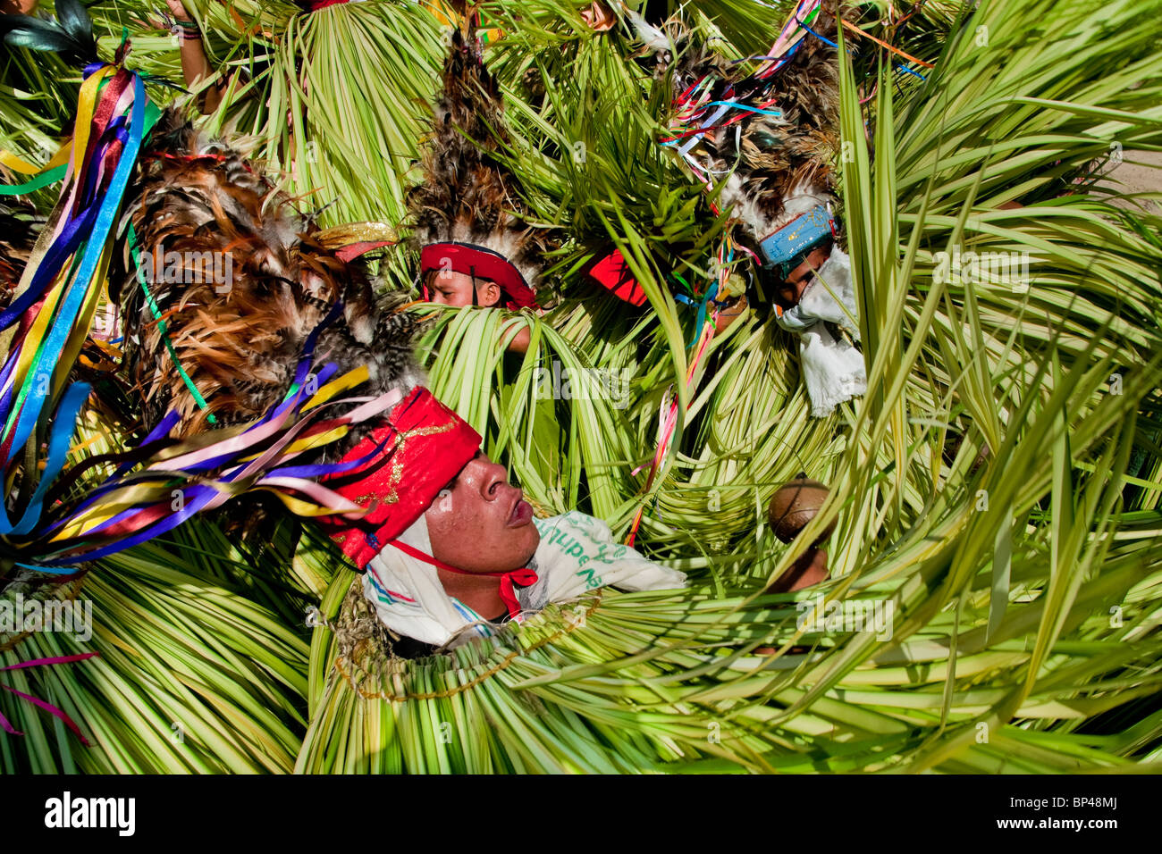 The Cucambas dancers whirl wildly around in the religious procession in ...