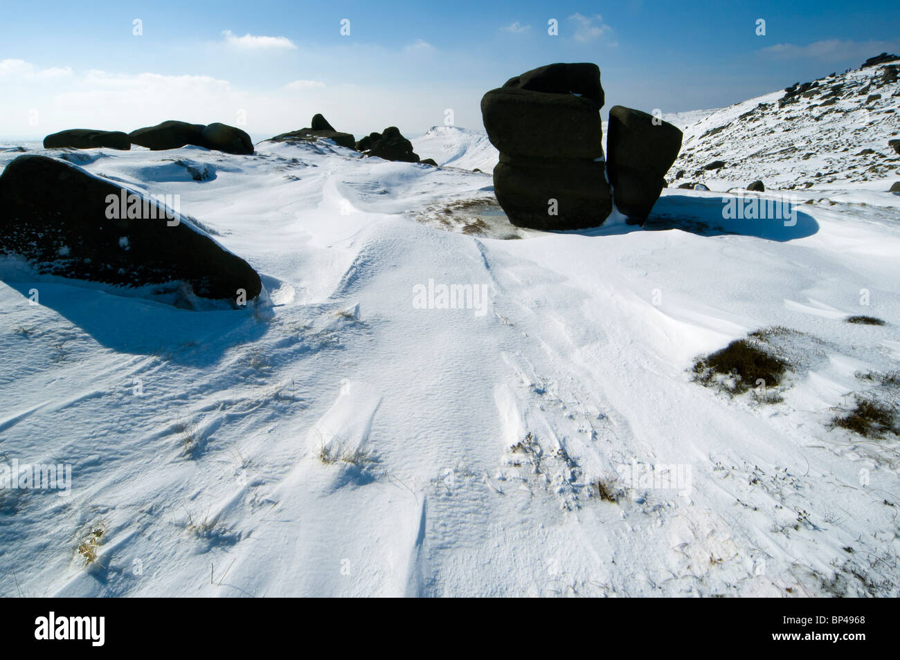 Snow and rocks on the Kinder Scout plateau in winter, Peak District ...