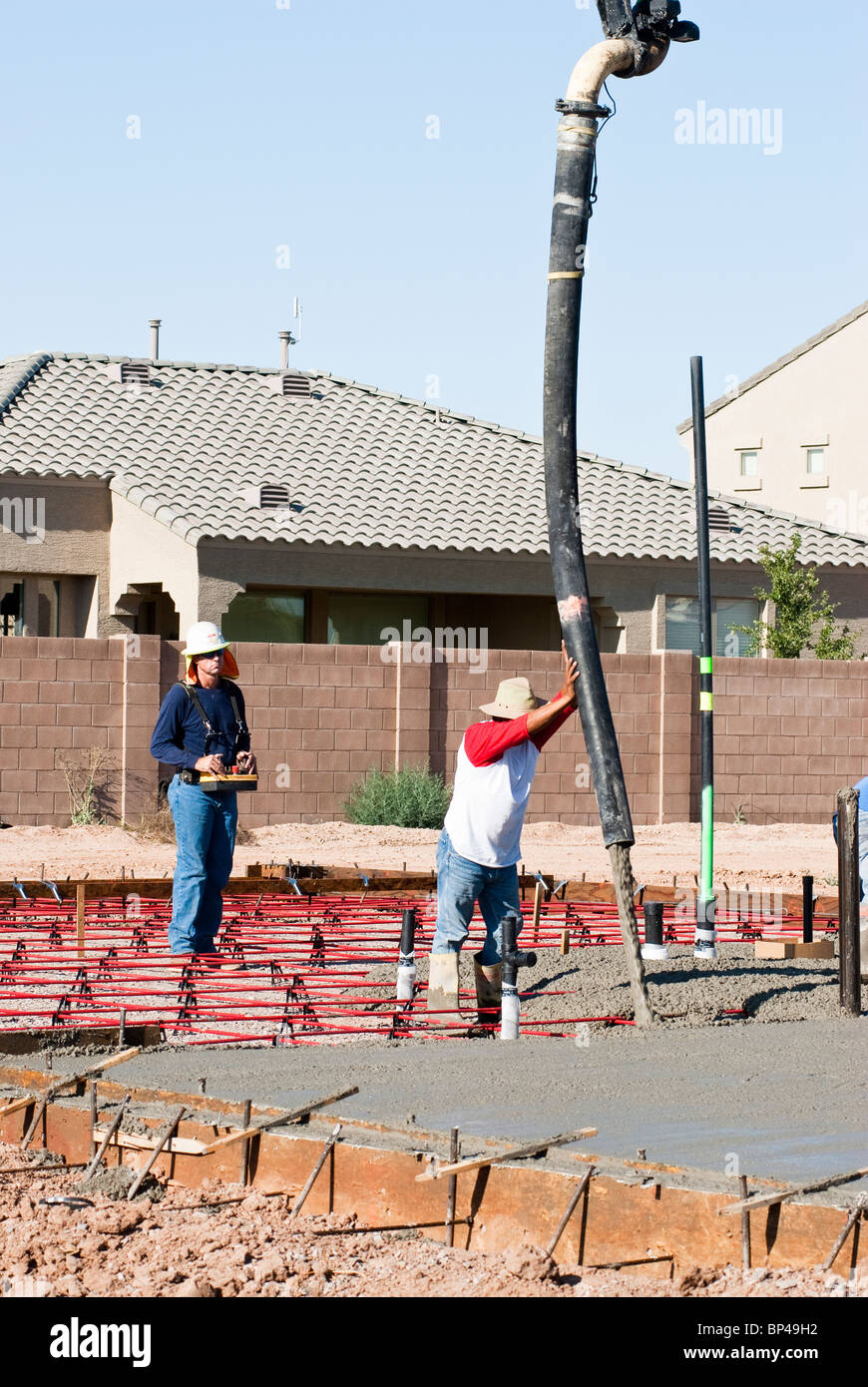 Construction workers pour a concrete pad for a new house Stock Photo ...