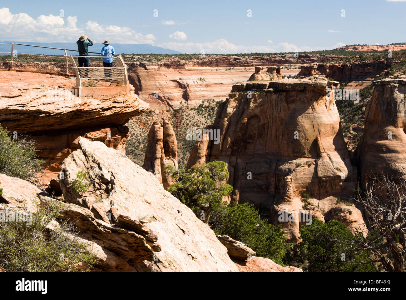 Visitors enjoy the view at an overlook along the Rim Rock Drive in the ...