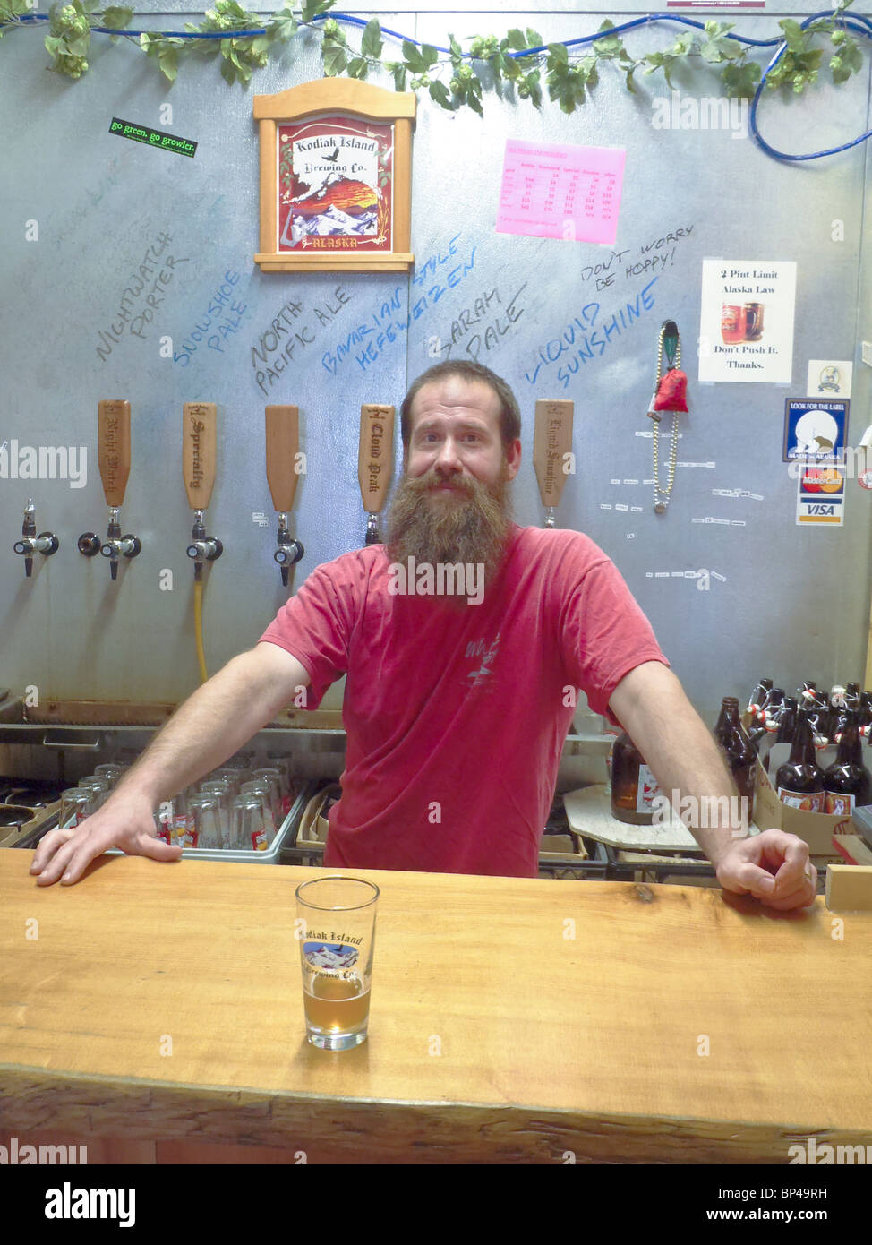 An Alaskan Brewmaster offers a sample from his microbrewery, at the ...