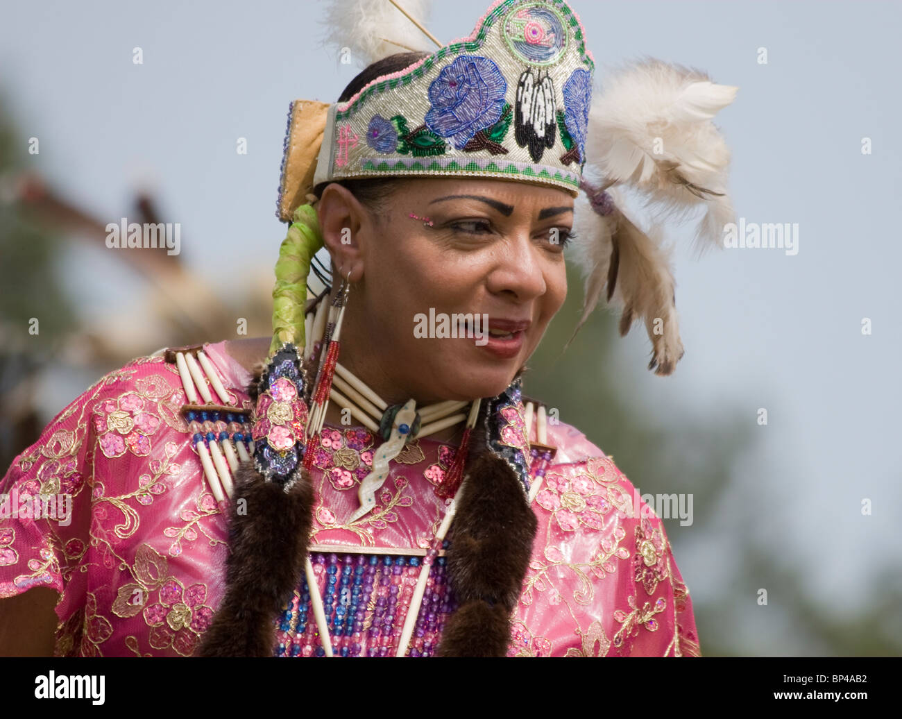 A Native American woman dances in full traditional regalia at the 8th ...
