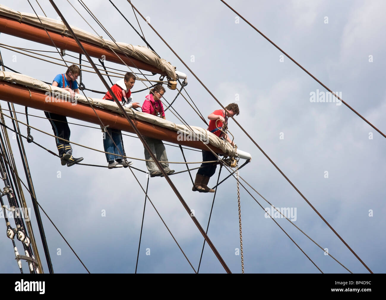 Members of the crew of a square rigged sailing ship working on the ...