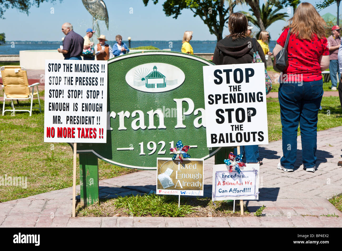 Signs protest taxes and government spending at the entrance to a Tea ...