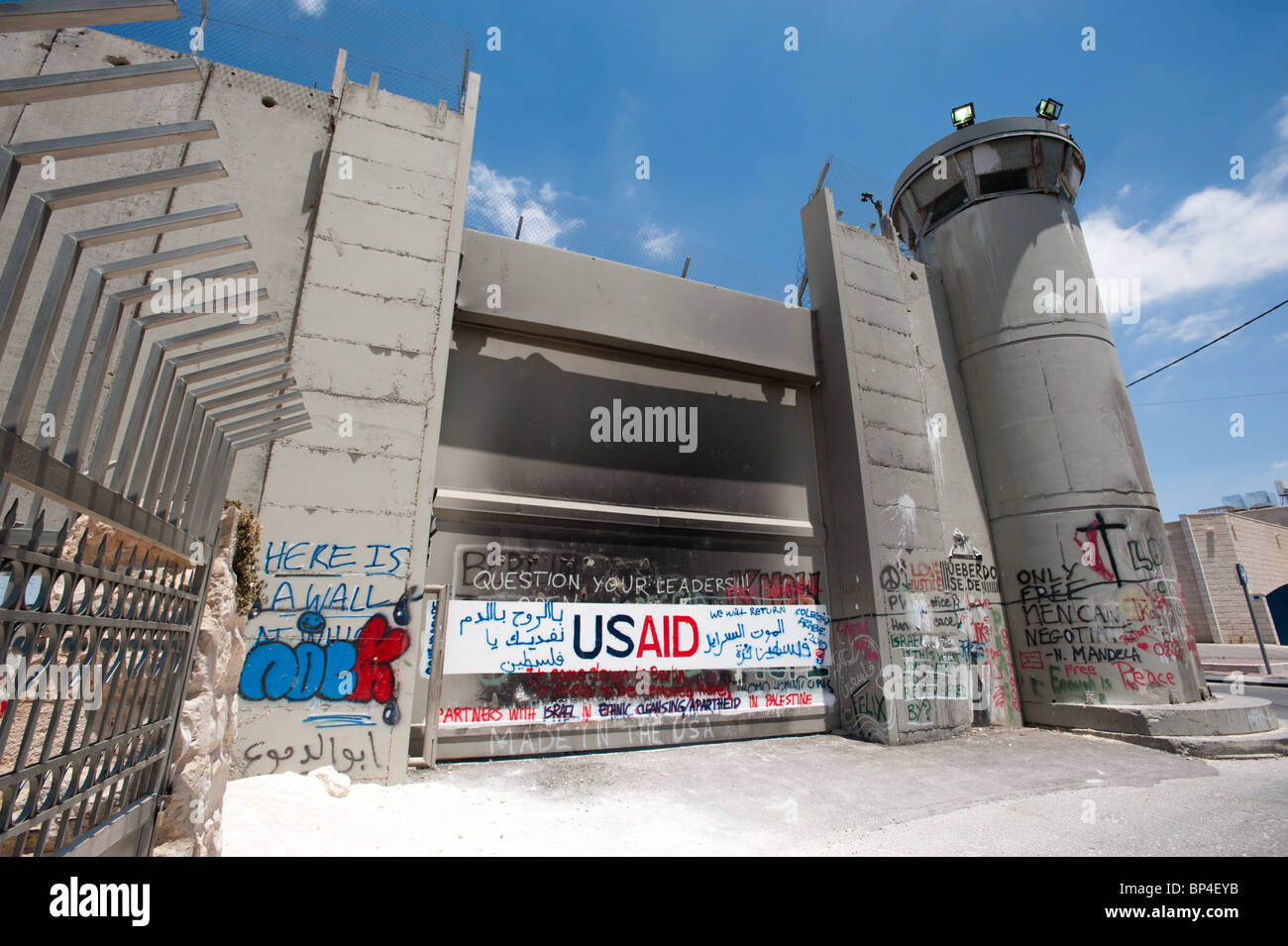 Activist graffiti adorns the Israeli separation wall in the West Bank ...