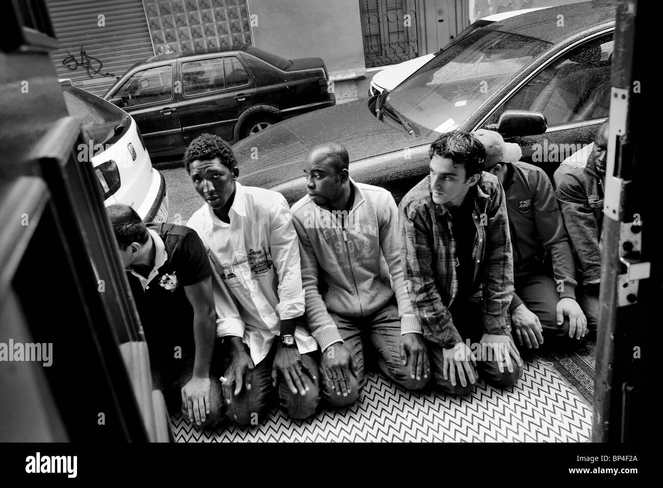Young Muslims praying on the street in front of the Assalam Mosque in ...
