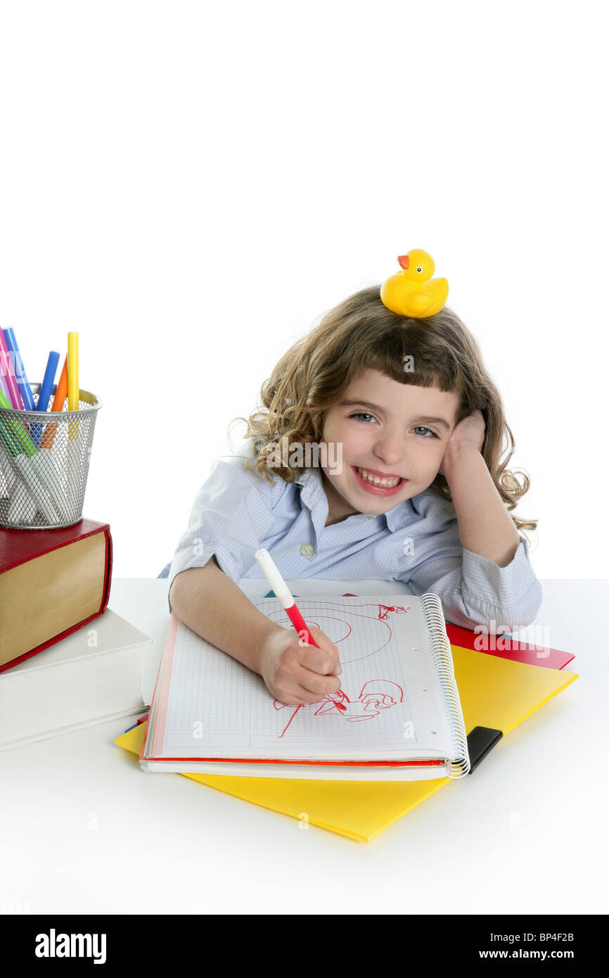 little girl happy student on desk writing and smiling Stock Photo - Alamy