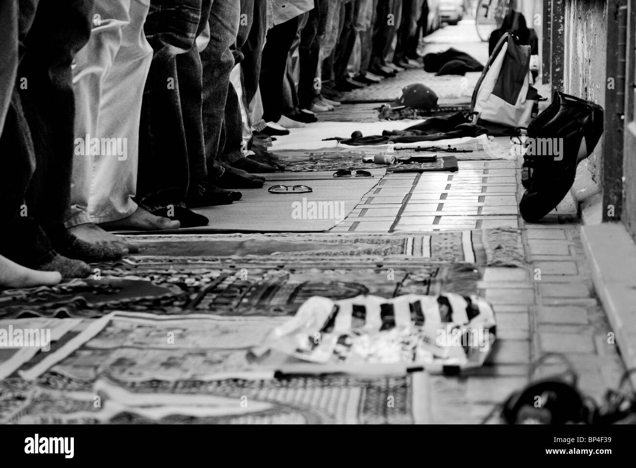 Barefooted Muslims praying on the street in front of the Assalam Mosque ...