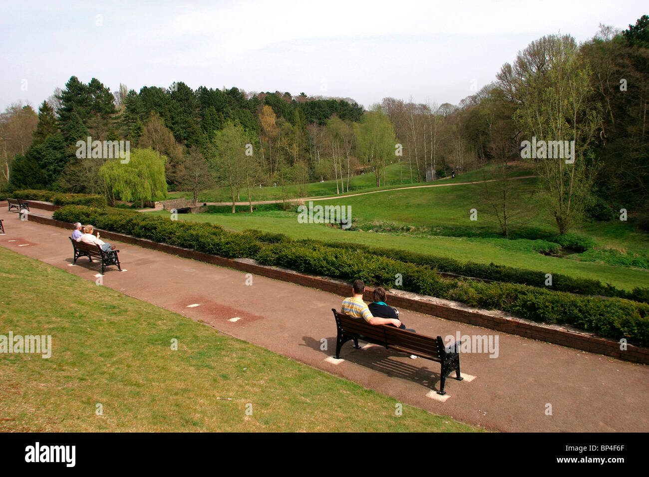UK, England, Cheshire, Stockport, Bramall Hall, people sat relaxing on ...
