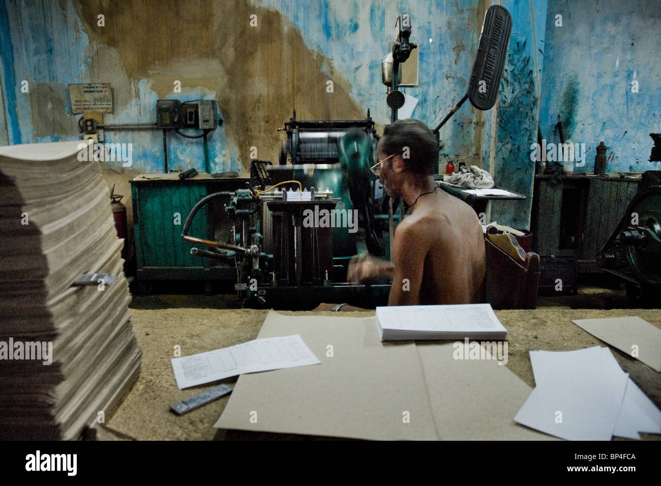 A Cuban master printer operating a printing machine in the state print ...