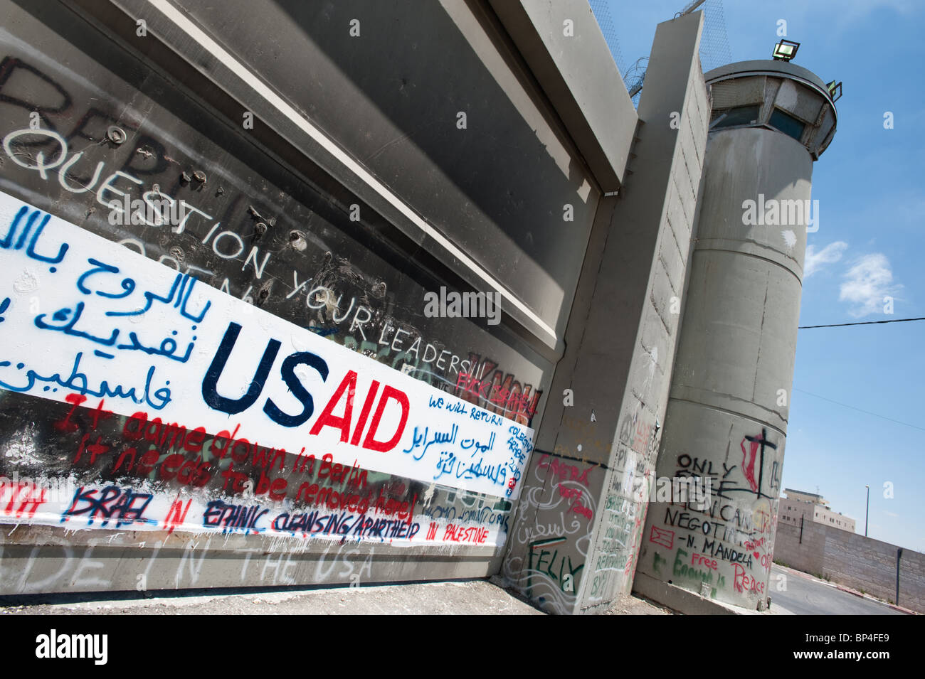 Activist graffiti adorns the Israeli separation wall in the West Bank ...