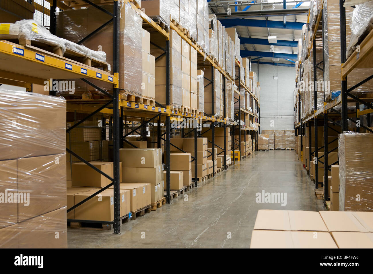 industrial warehouse interior with shelves and pallets with cartons ...