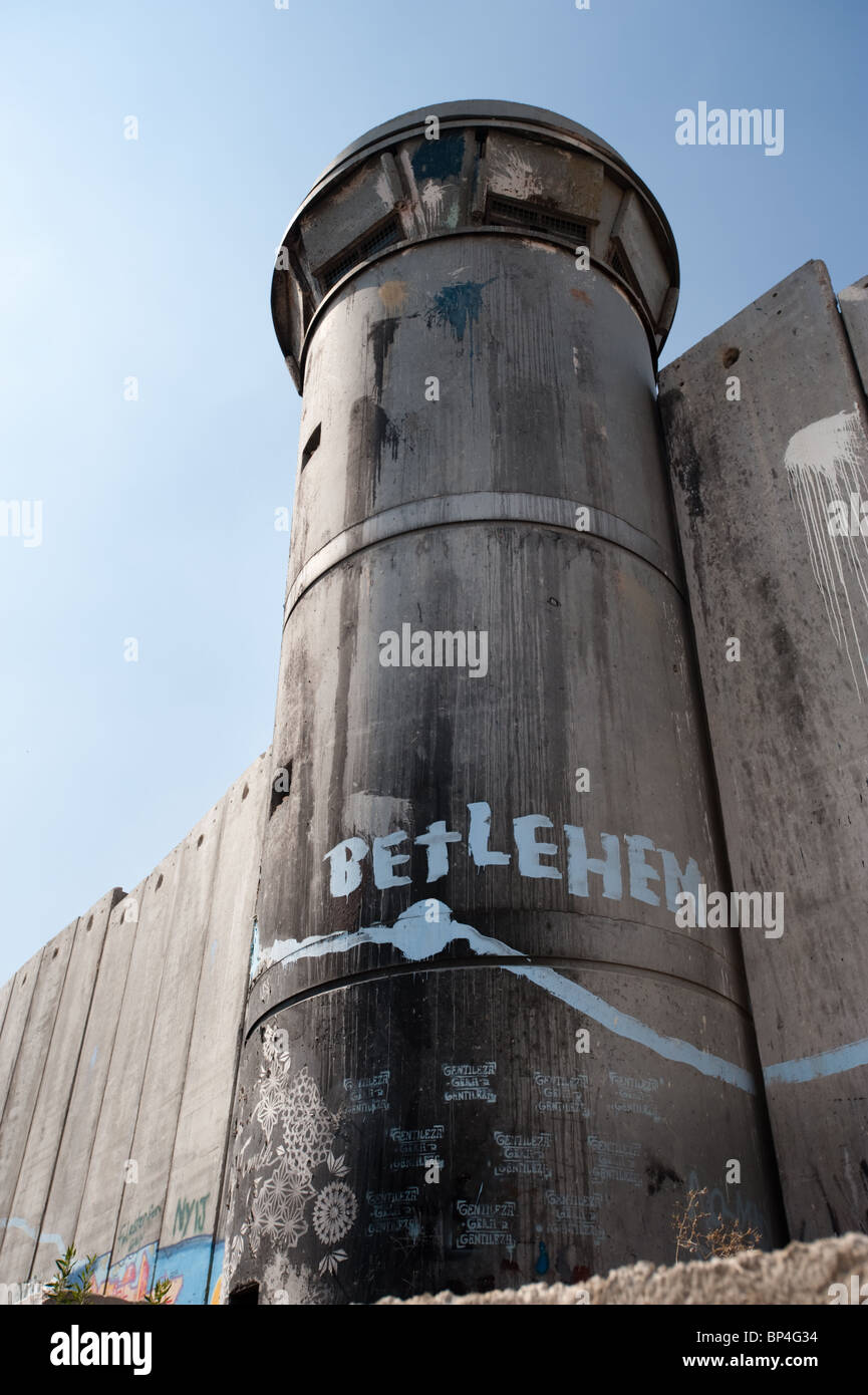 Activist graffiti adorns the Israeli separation wall in the West Bank ...