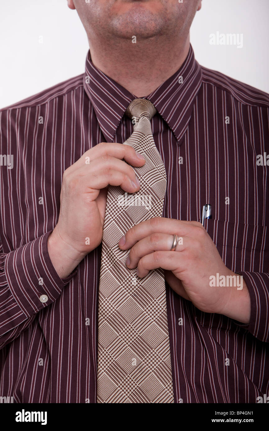 Man fixing tie Stock Photo - Alamy
