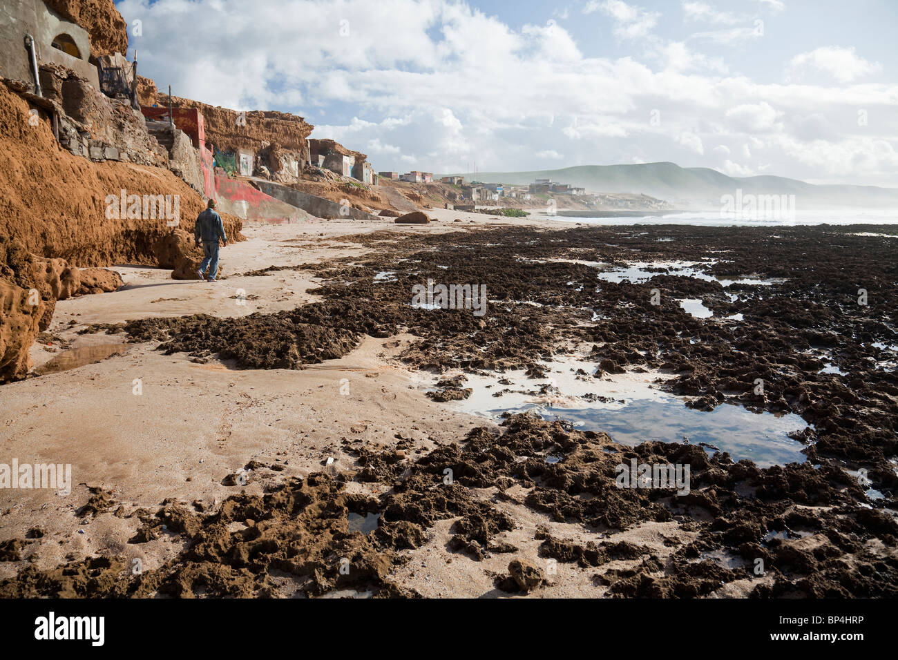 Plage Aglou coastline with distant fisherman's houses set into the ...