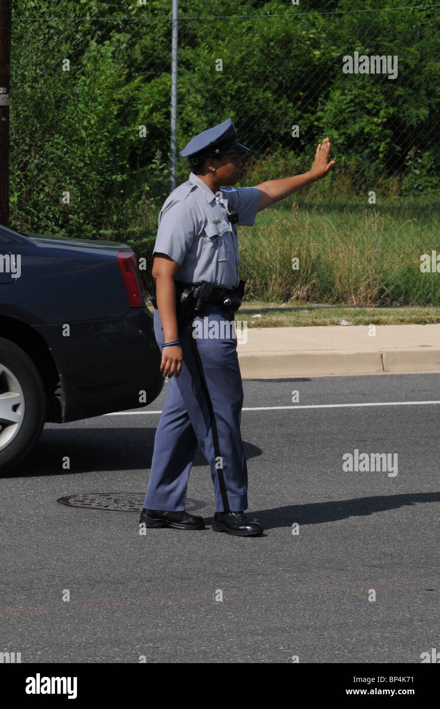 Policewoman directing traffic Stock Photo - Alamy