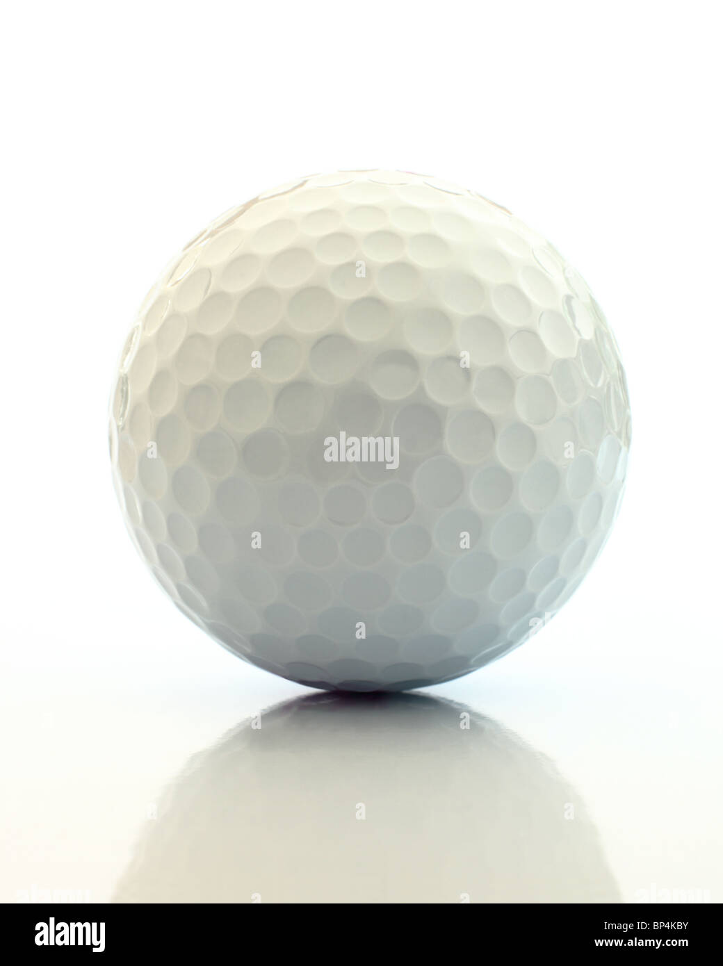 Single golf ball reflected on a white background. This image is ...