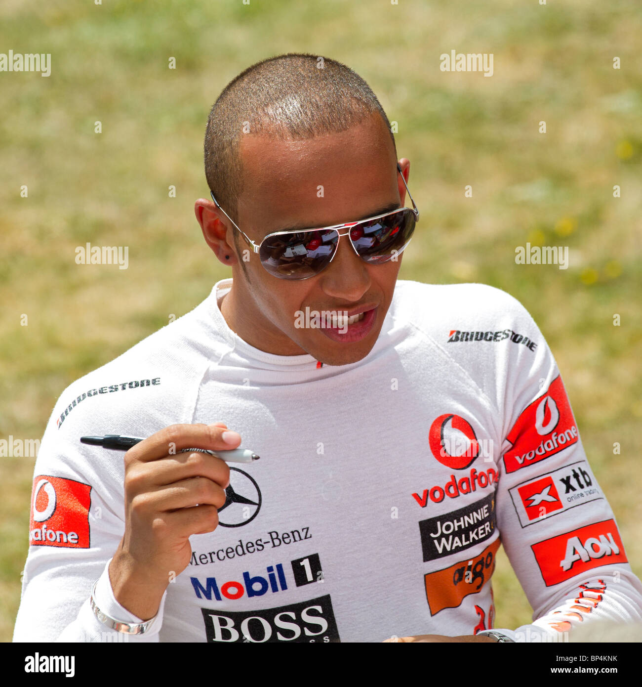 Lewis Hamilton signing autographs at the 2010 Goodwood Festival of ...