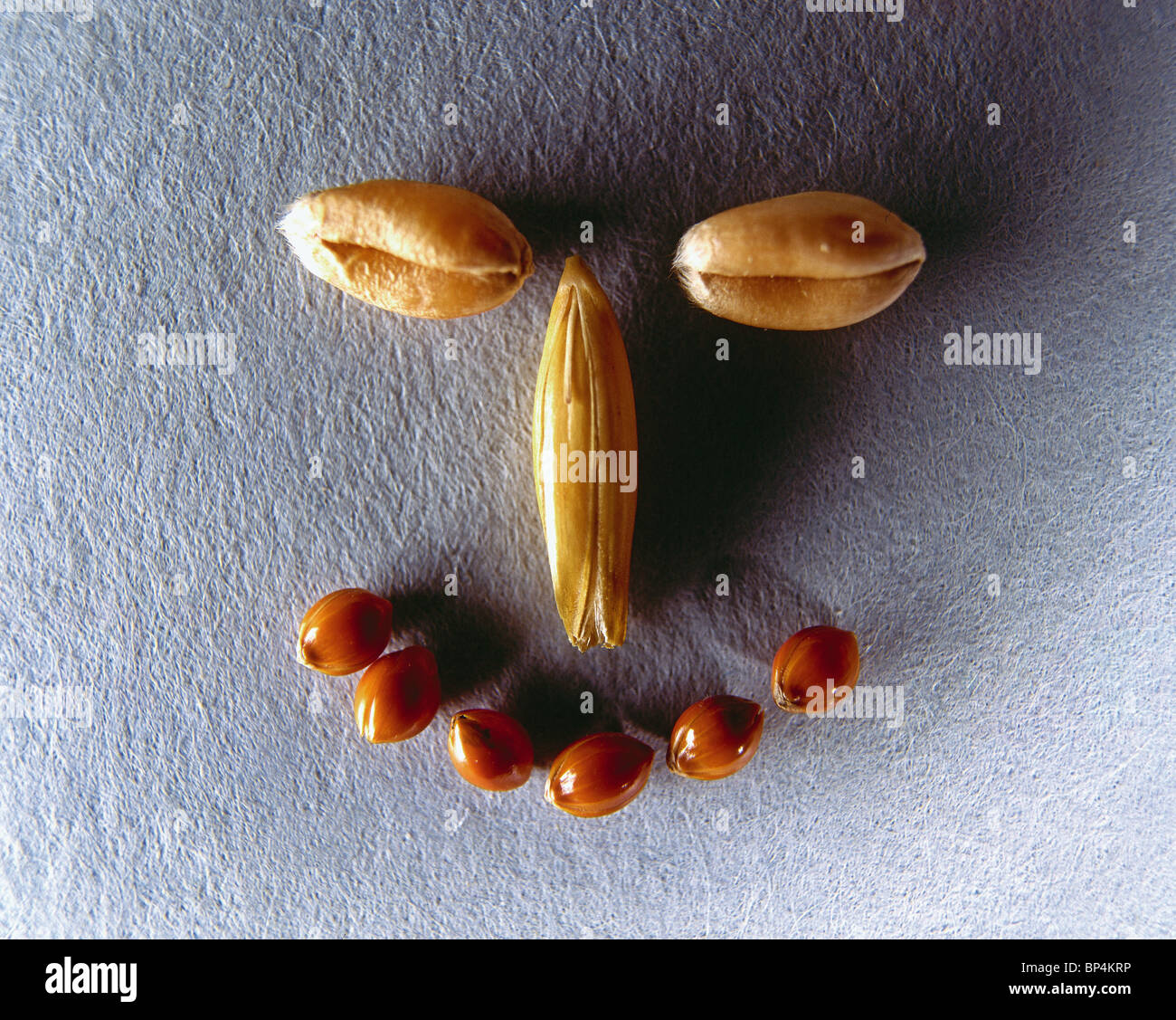 Smiley face maid of grain on a gray paper Stock Photo - Alamy